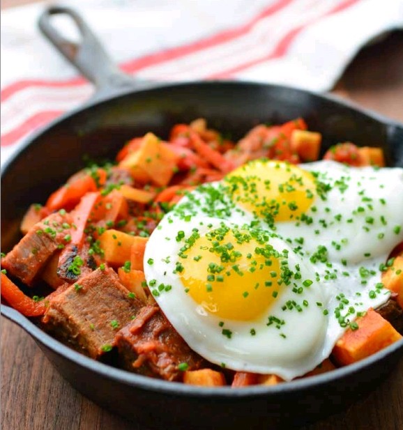 Spicy tomato and burnt-ends hash with fried eggs recipe | Eat Your Books